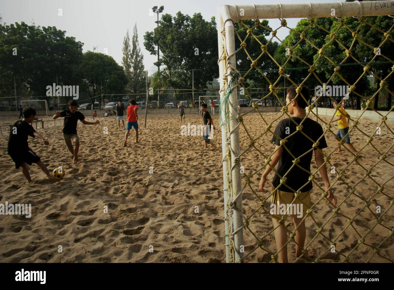 Young men playing beach soccer (beach football, sand football, beasal ...