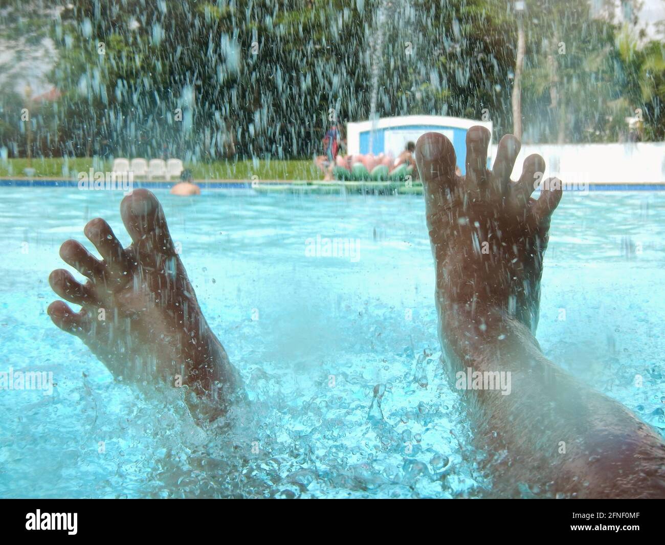 Two feet with fanned toes under water droplets from a fountain at The ...