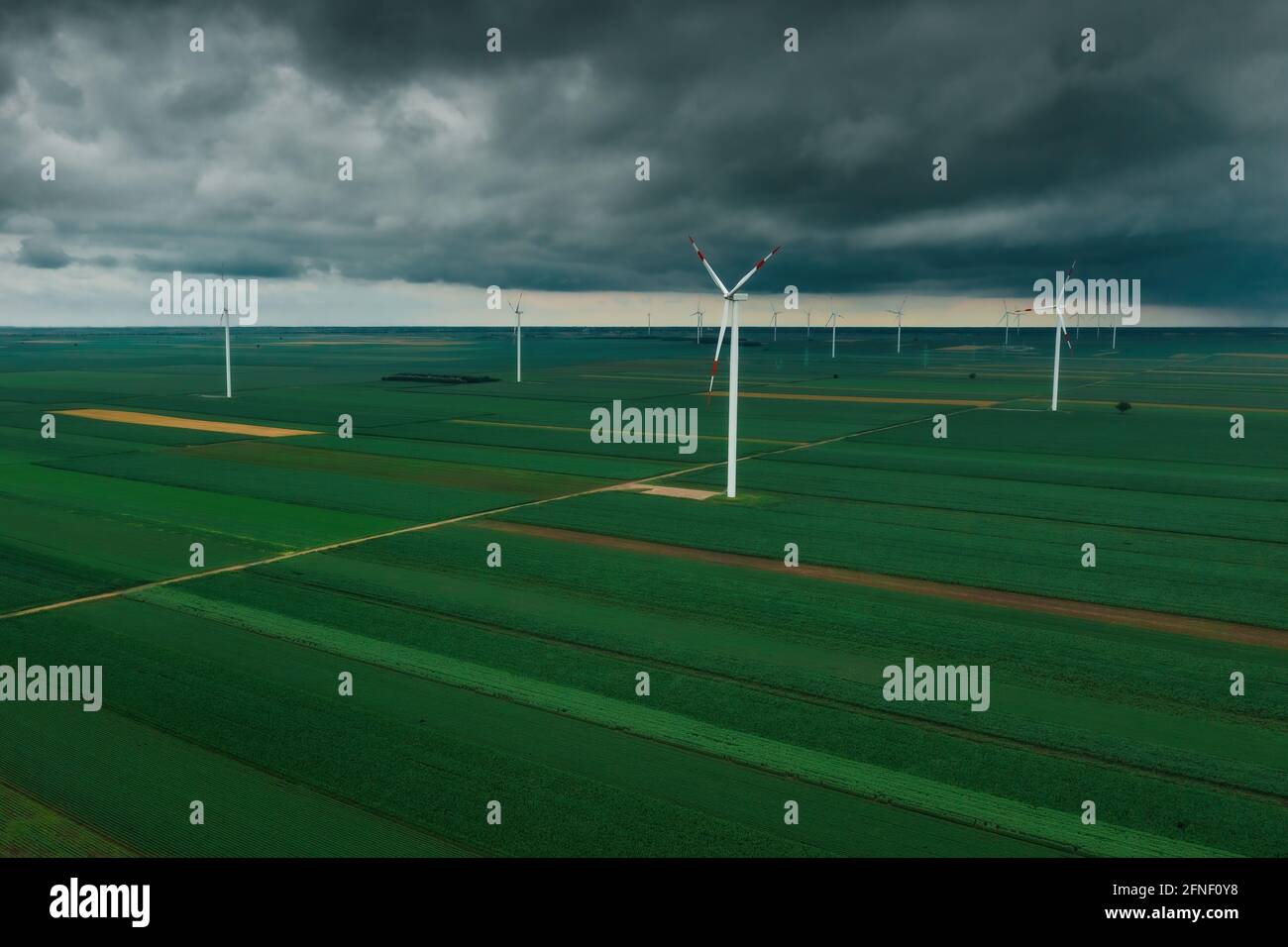 Aerial view of wind turbines on renewable green energy wind farm from ...