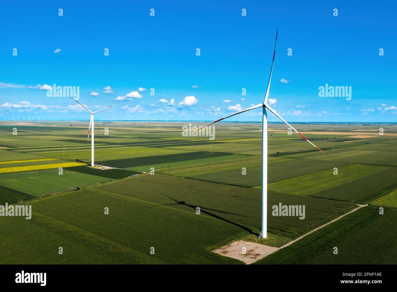 Aerial view of wind turbines on modern wind farm from drone pov, high ...