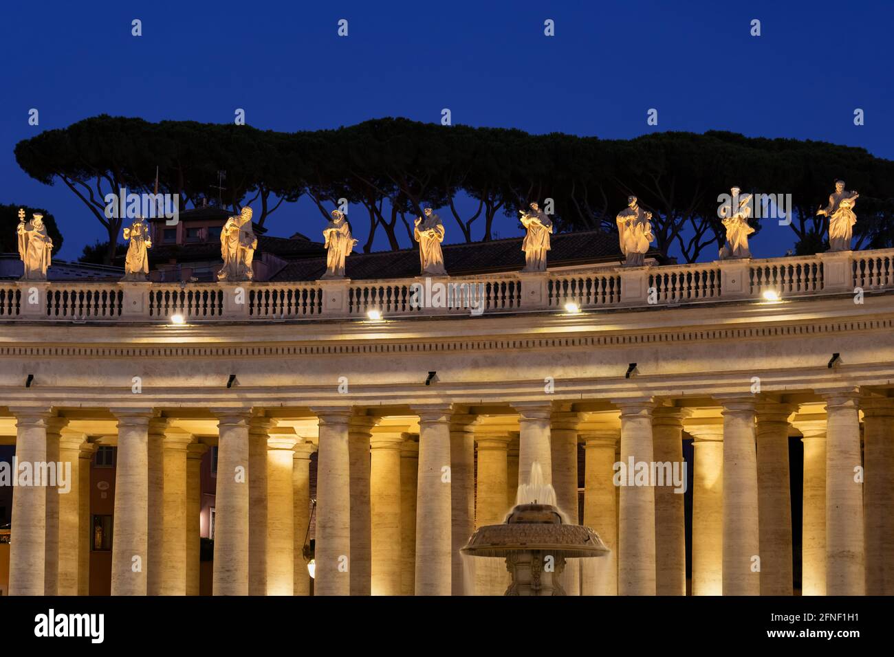 Vatican, monumental colonnade by Bernini illuminated at night on St Peter Square, Doric style ...