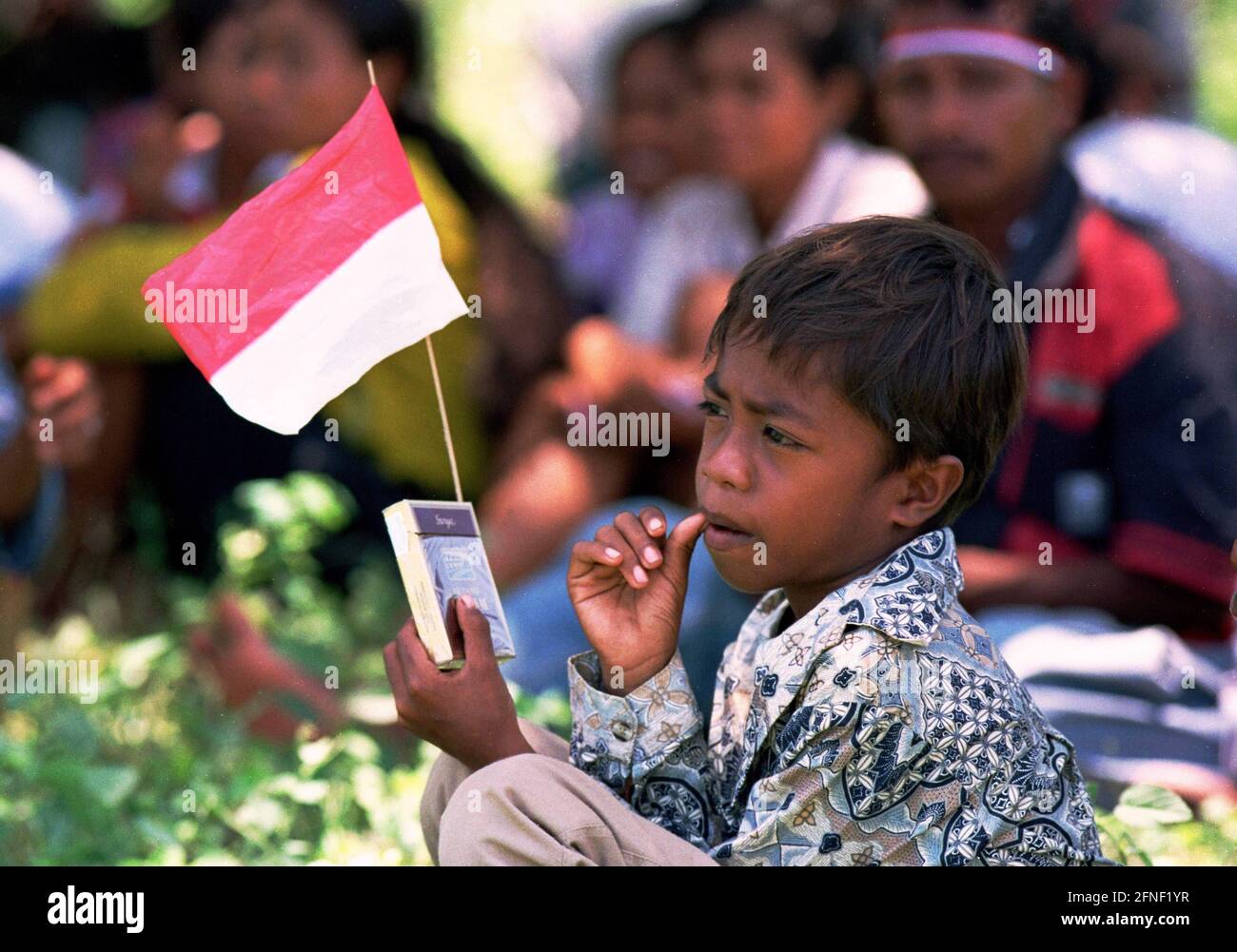 A young boy with the Indonesian flag at a gathering of pro-Indonesian ...