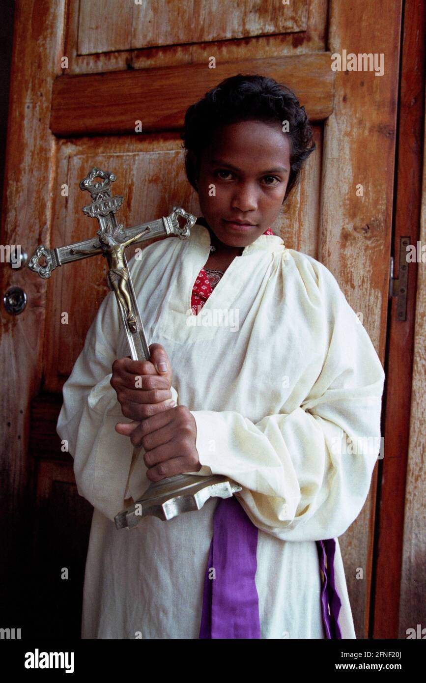 Girl with cross on the day of his communion in East Timor. [automated ...
