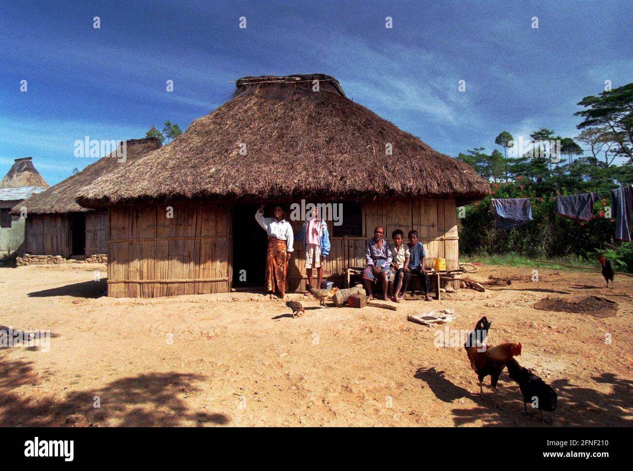 A family in front of their typical house in a village in the highlands ...