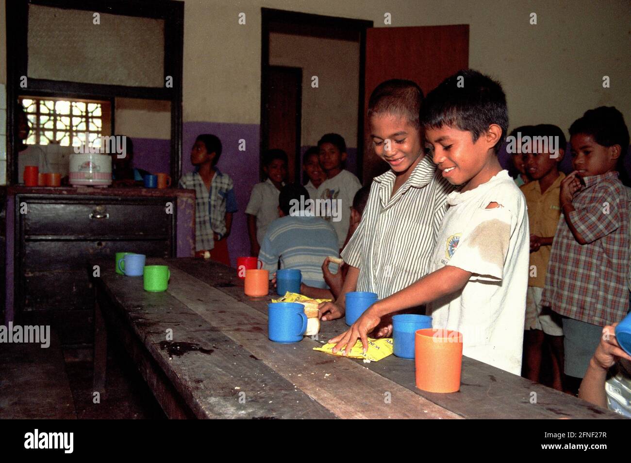 Children at the Panti Asuhan Seroja orphanage clearing dishes in the ...