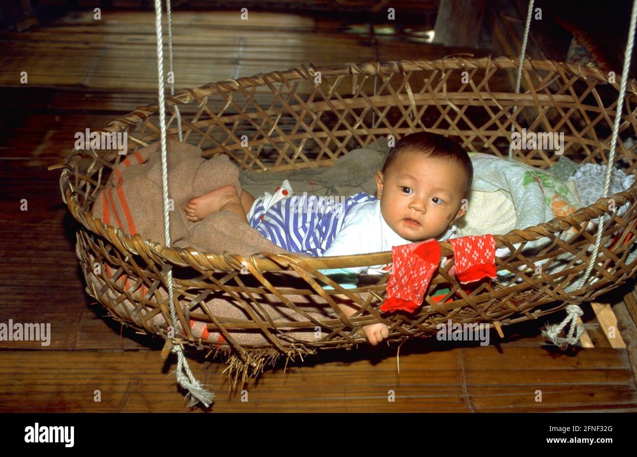 Cradle with baby in a Hmong village north of Hanoi. The Hmong are one ...