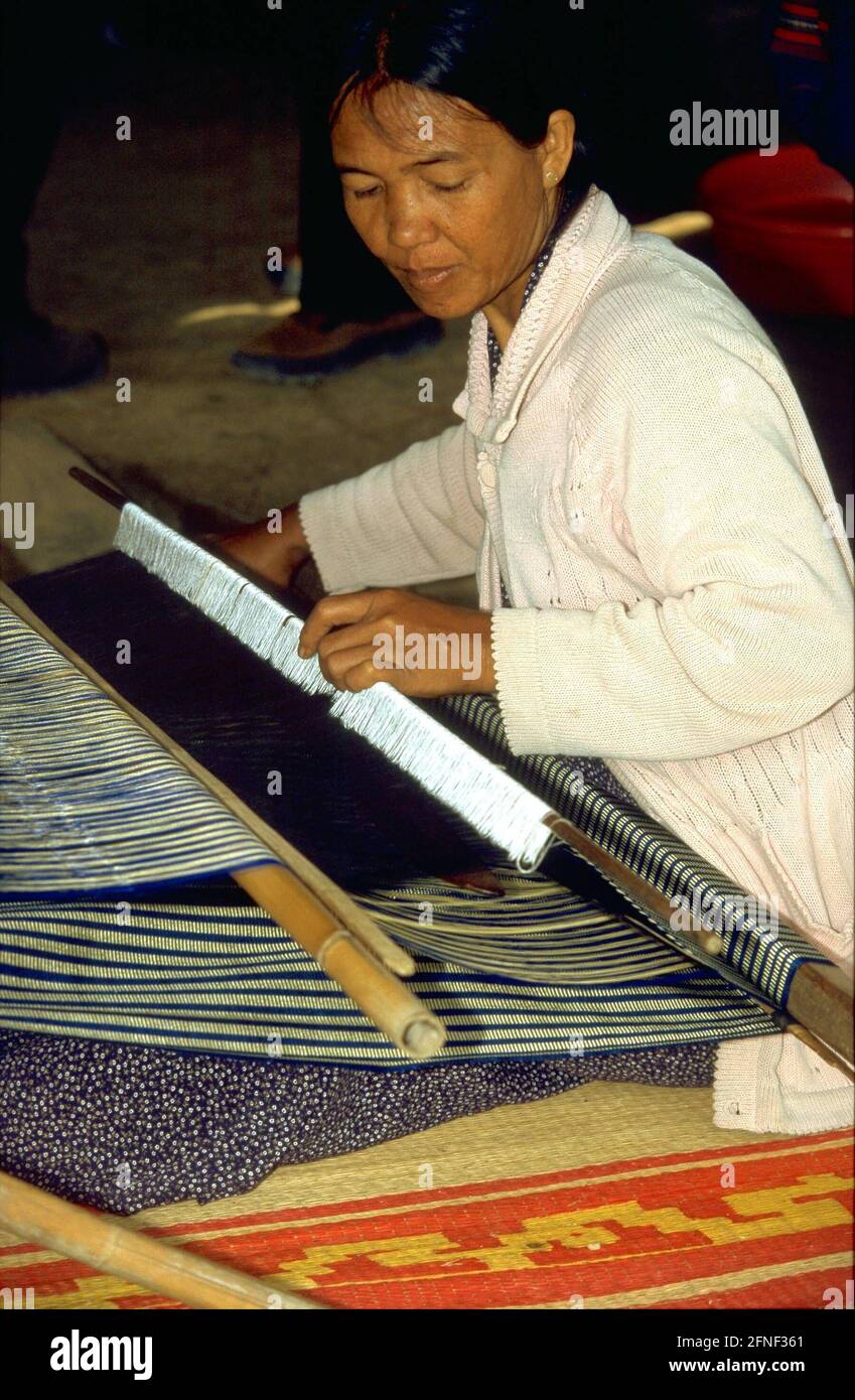 Weaver working at the loom in a village near Da Lat. [automated ...
