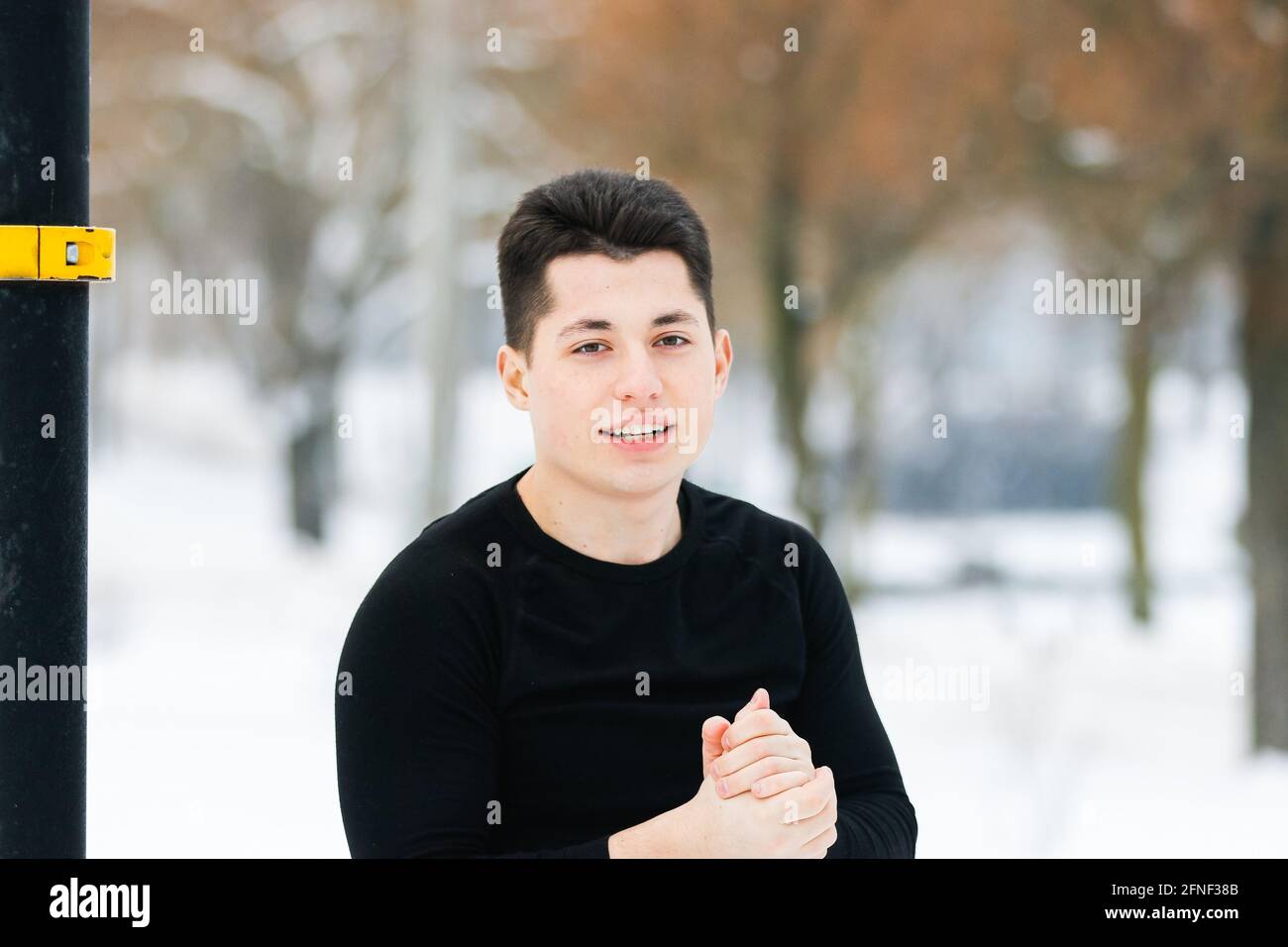 MINSK. BELARUS - January 2021: The young man warms his hands in winter ...