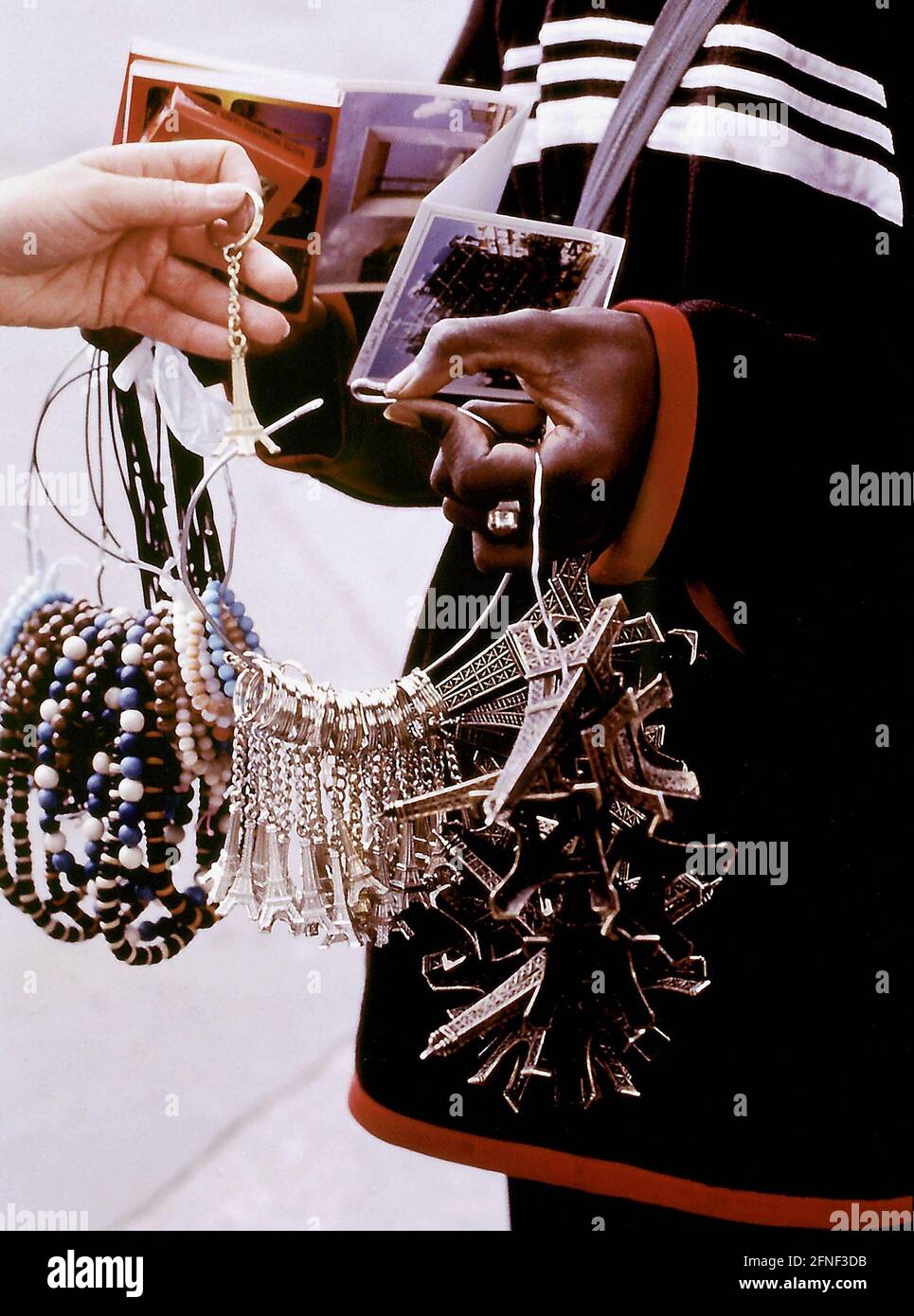 A tourist buys a souvenir from a souvenir seller. automated translation Stock Photo Alamy