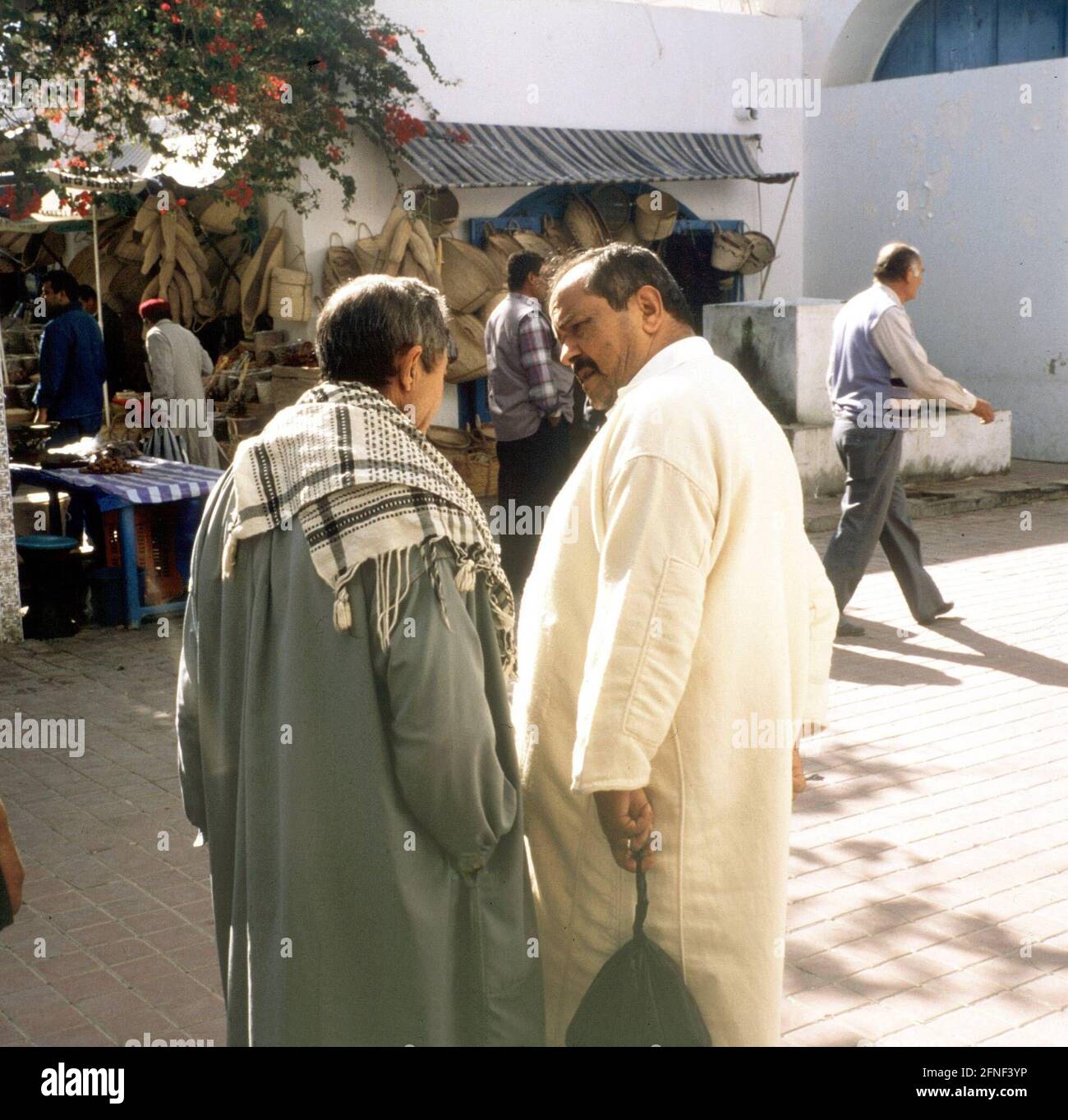 Men at the bazaar of Hound Souk on Djerba. [automated translation ...