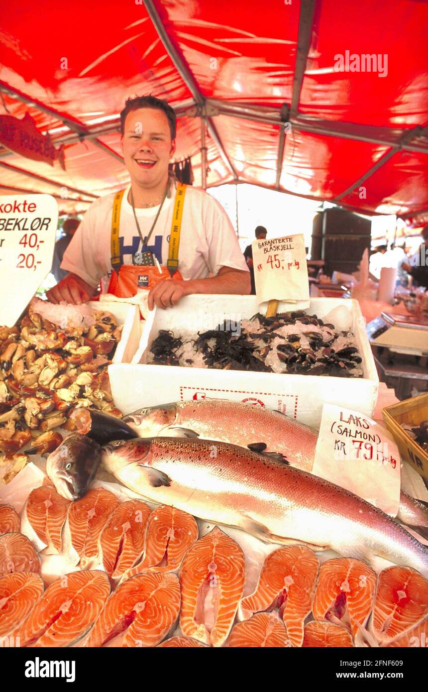A fish seller offers, among other things, salmon at a market stall in ...