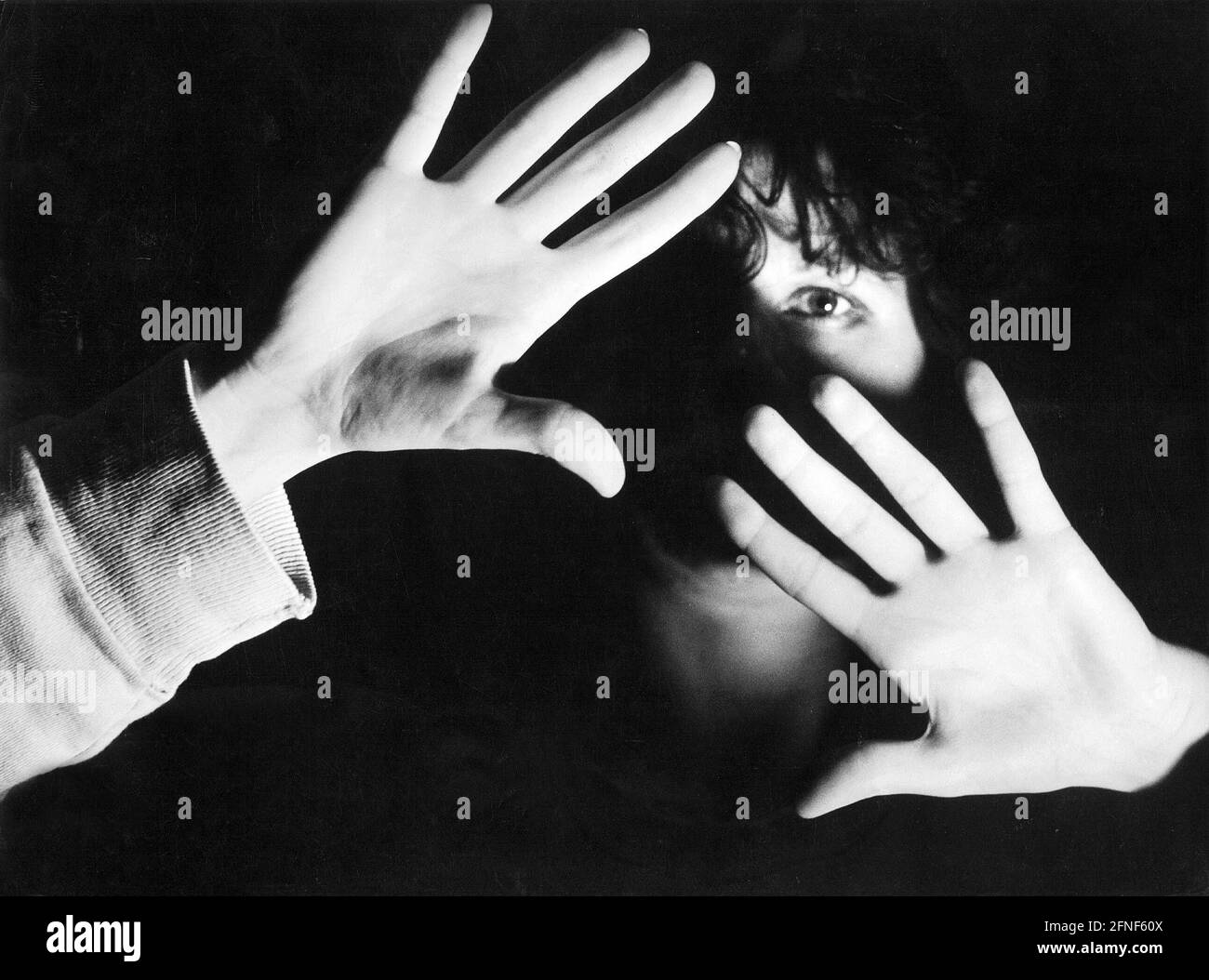 Man in fear, man or woman, with hands in defensive posture. [automated ...