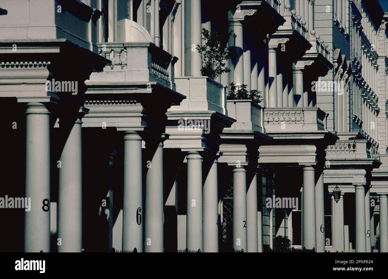 Detail of neoclassical house facades with double columns, cornices and ...