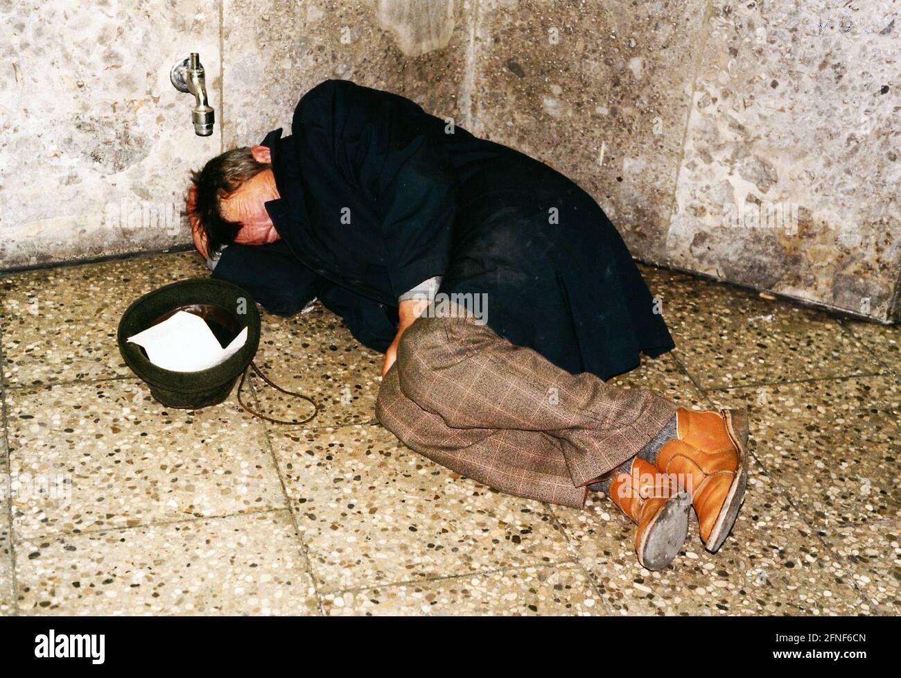 A homeless man sleeps on the subway floor at Sendlinger-Tor-Platz in ...