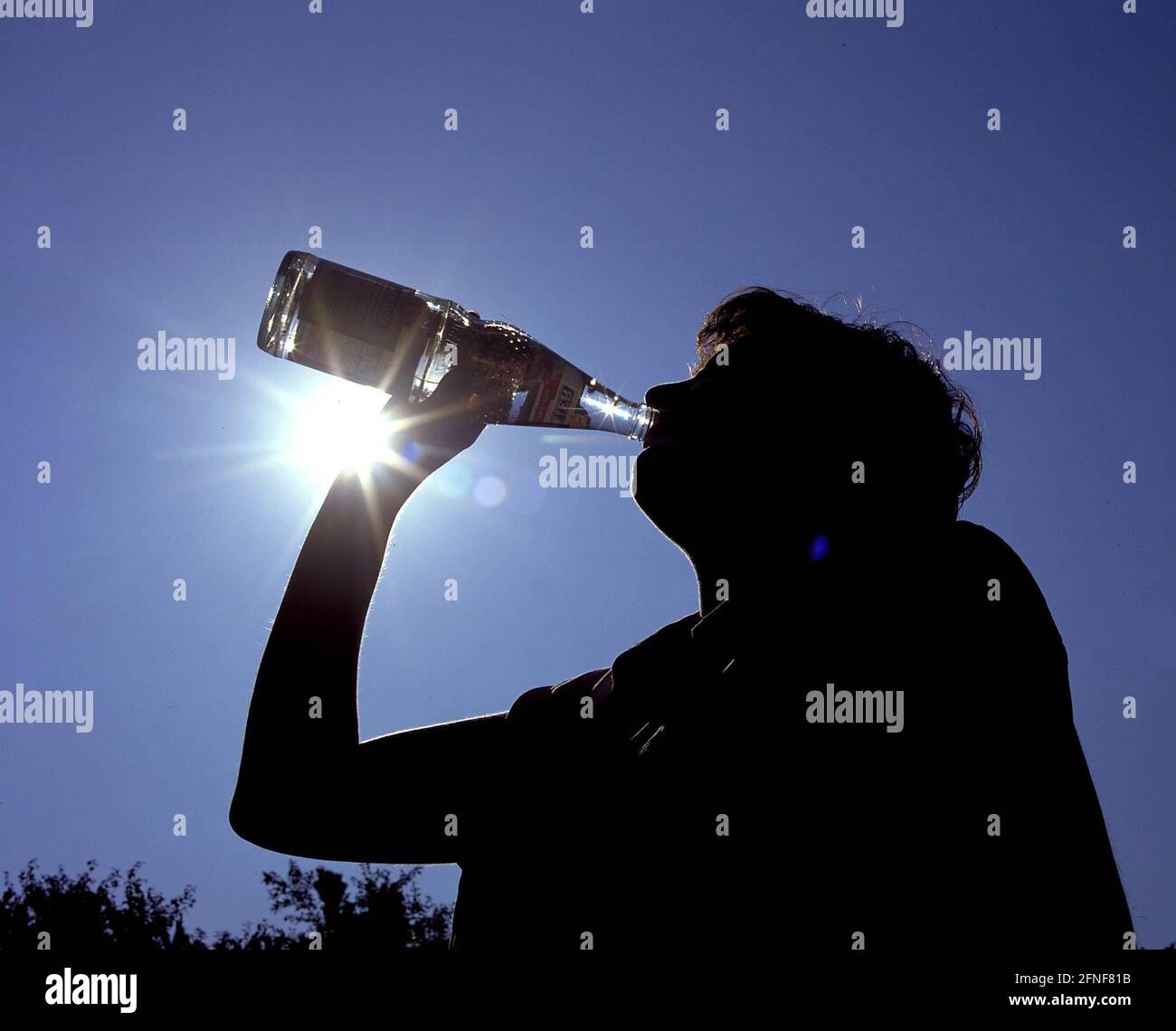 A woman drinks a bottle of fizz to quench her thirst. [automated ...