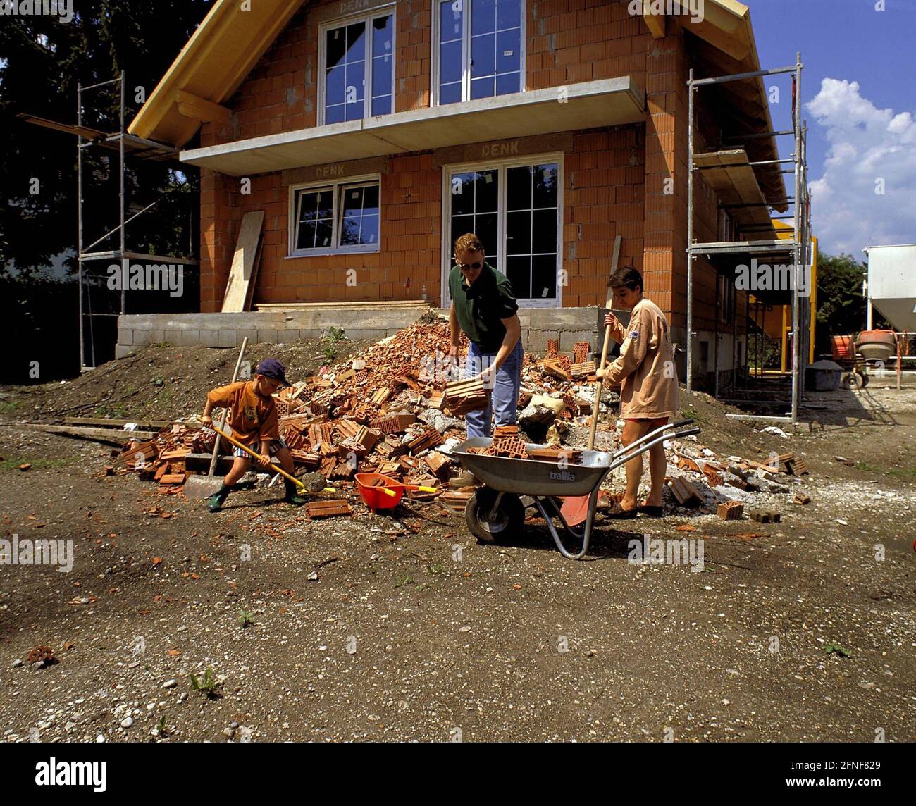 Small family building a house. [automated translation] Stock Photo - Alamy