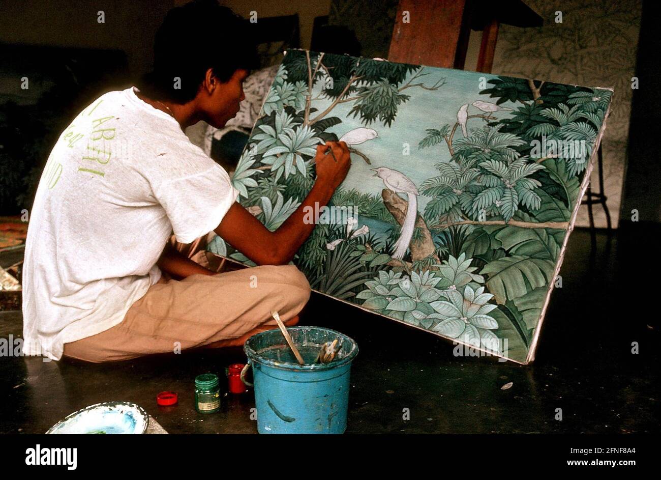 Young man painting a landscape with birds. [automated translation ...