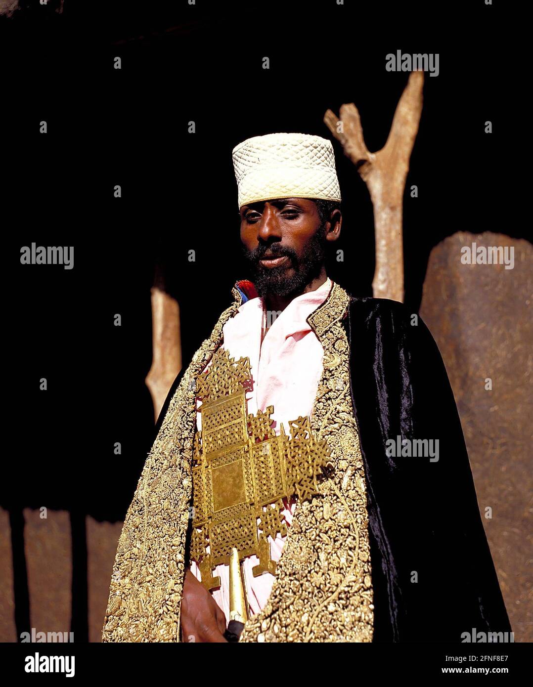 Ethiopian priest in regalia with gilded hand cross in the province of ...