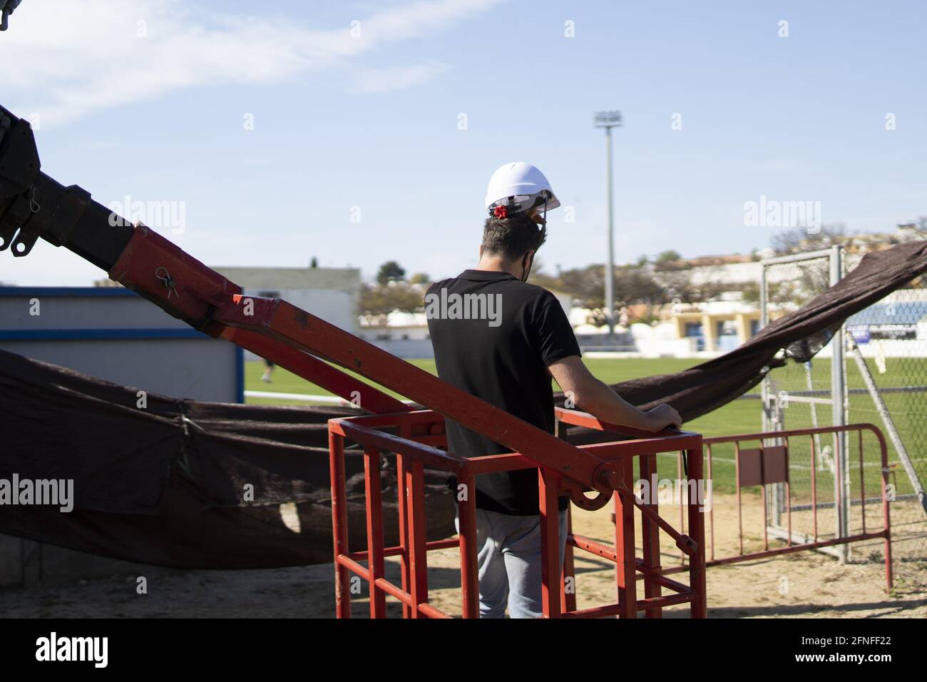 Closeup shot of an operator placing a camera on a suspension cable for ...