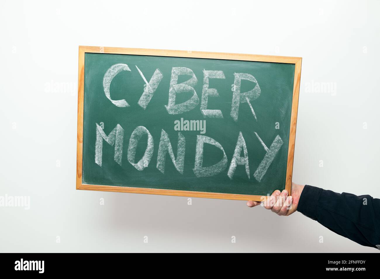 hand holding a chalkboard with the words CYBER MONDAY handwritten in ...