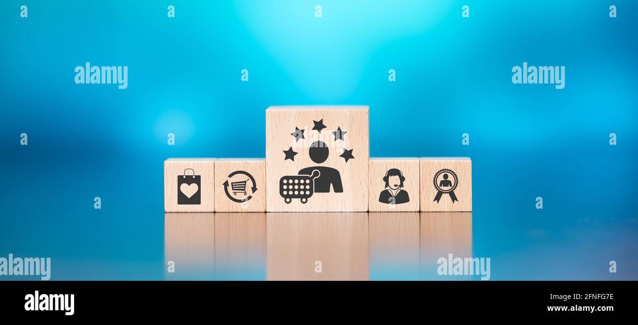 Wooden blocks with symbol of customer loyalty concept on blue ...
