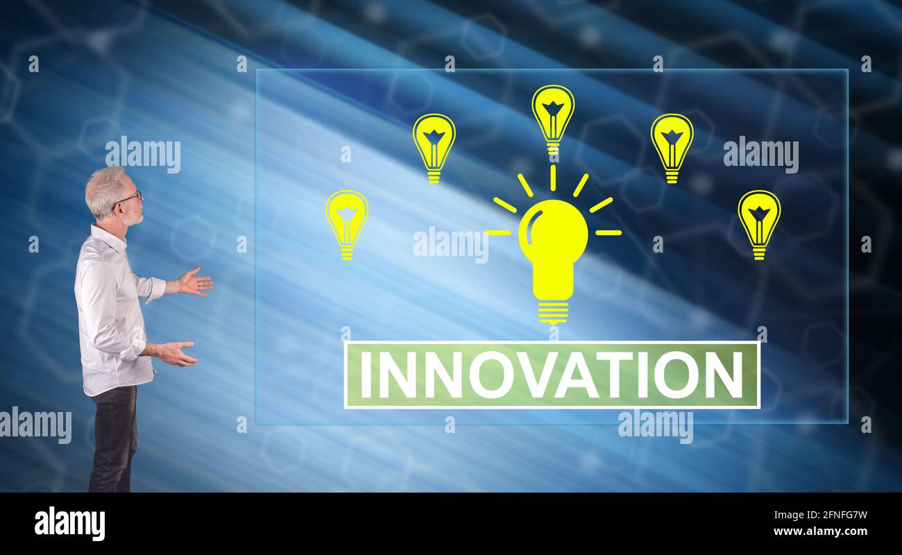 Businessman showing an innovation concept on a wall screen Stock Photo ...