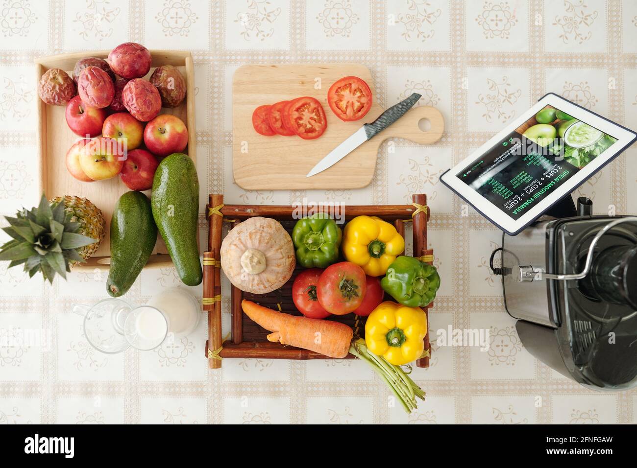 Tray with fresh vegetables, cutting board, knife and tablet computer ...