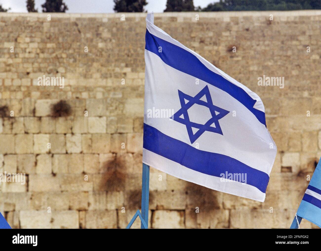 The Israeli national flag in front of the Jerusalem Wailing Wall. The ...