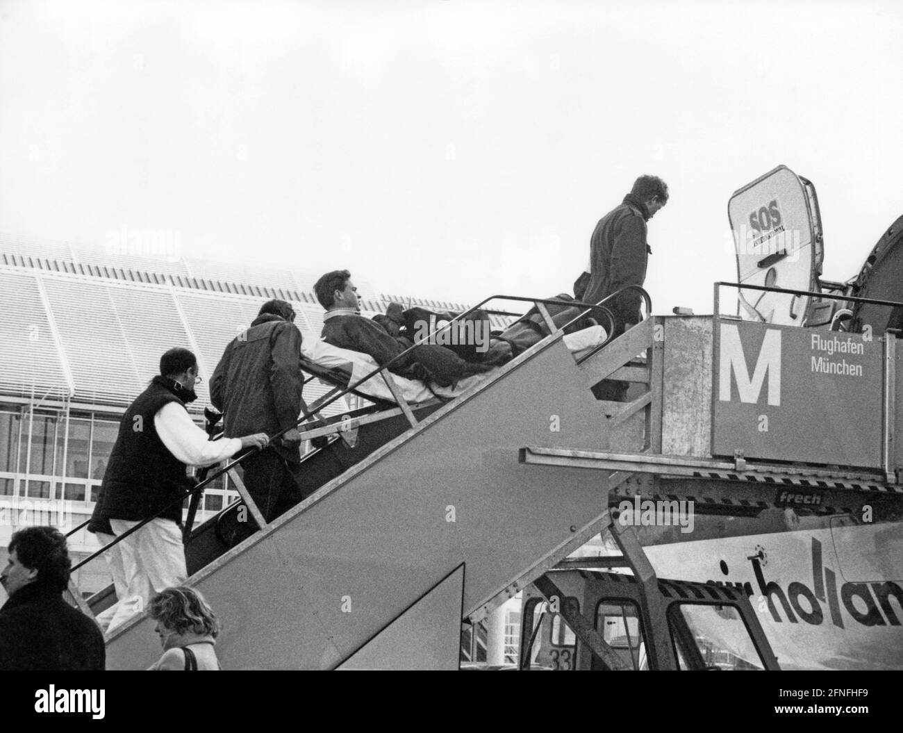 A man is being loaded onto an airplane for transport. [automated ...