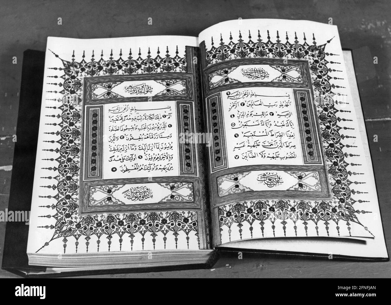 Open Koran with elaborately calligraphed pages. [automated translation ...
