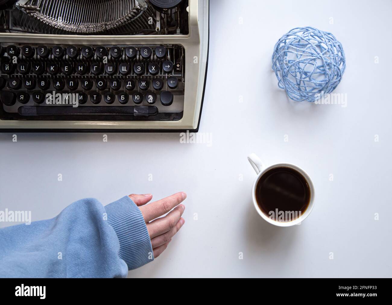 Flat lay composition with a typewriter, a cup of coffee and a woman's ...