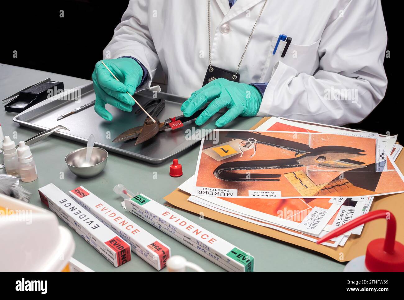 Police scientist extracts DNA sample from a pair of pliers in a crime ...