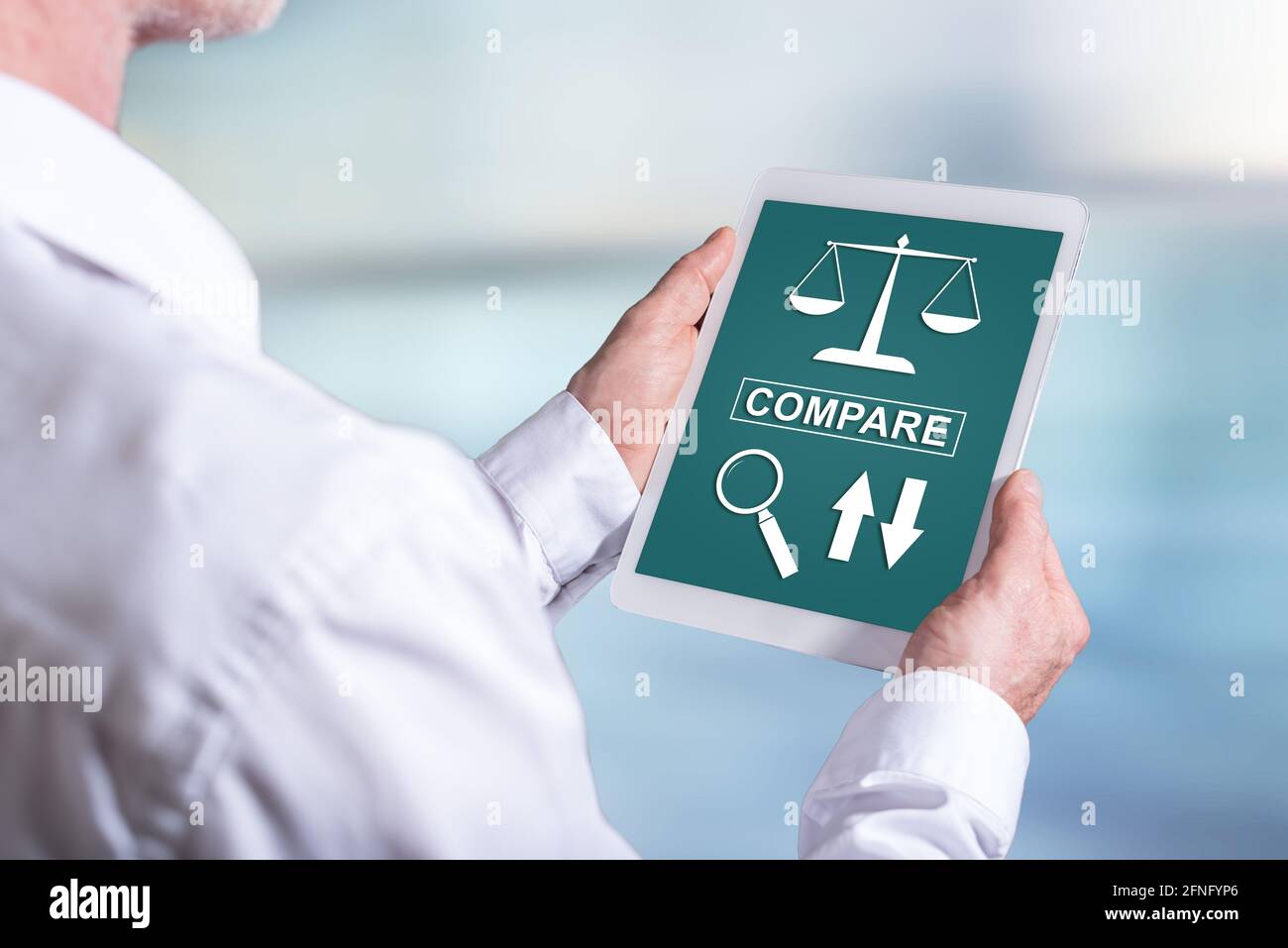Tablet screen displaying a compare concept Stock Photo - Alamy