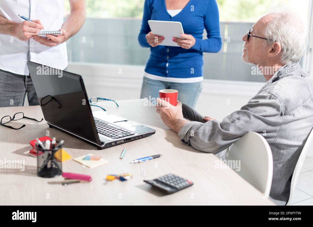 Coworkers having a business discussion in office Stock Photo - Alamy