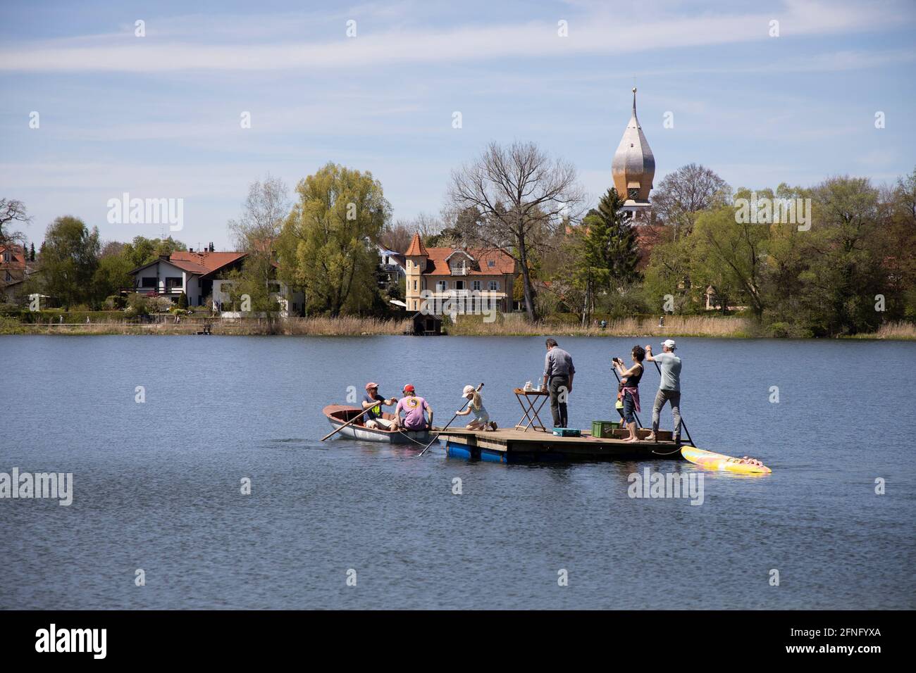 Group of people towing diving platform into the middle of Lake Wessling ...