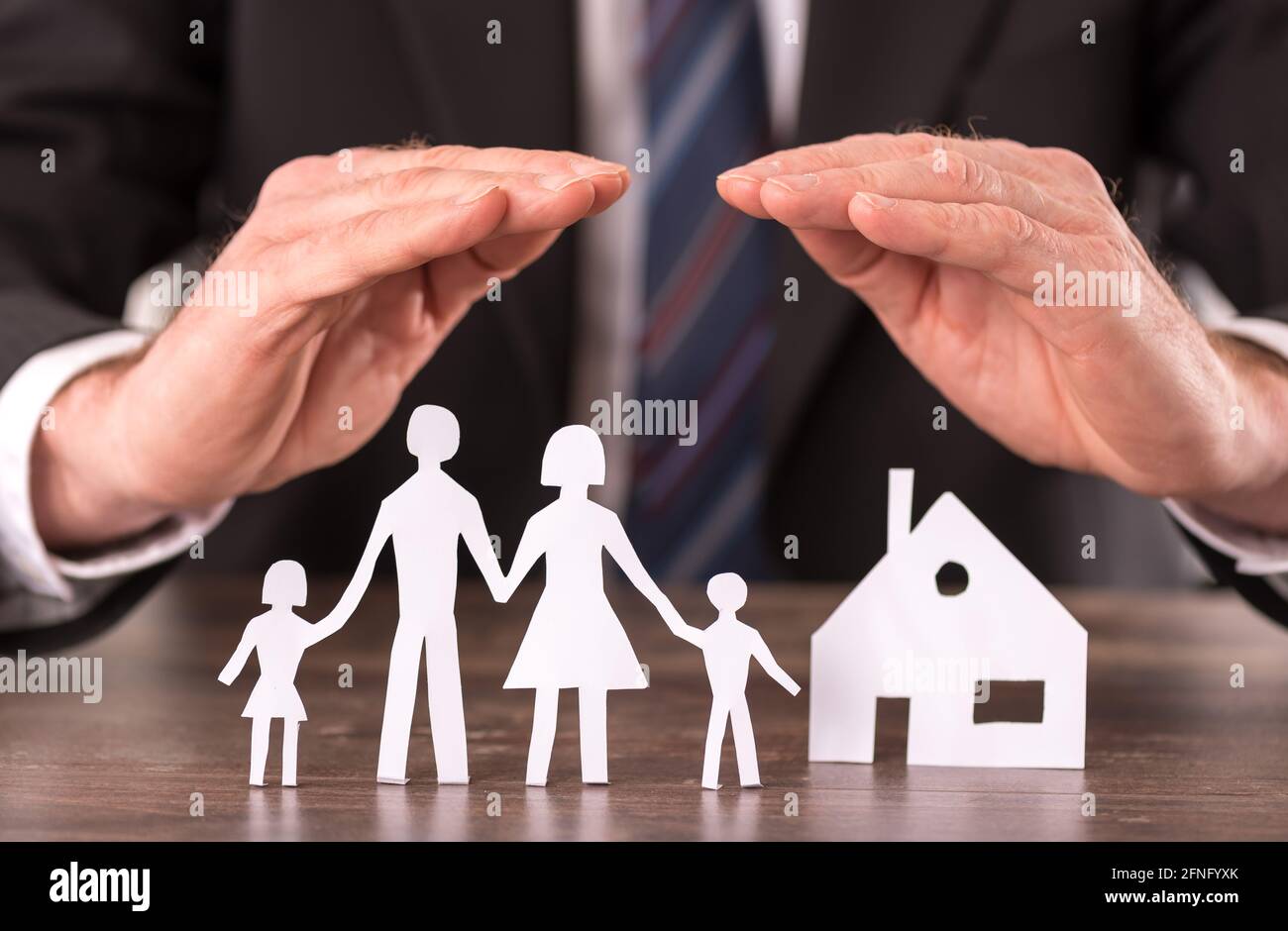 Concept of insurance with hands over a house and a family Stock Photo ...