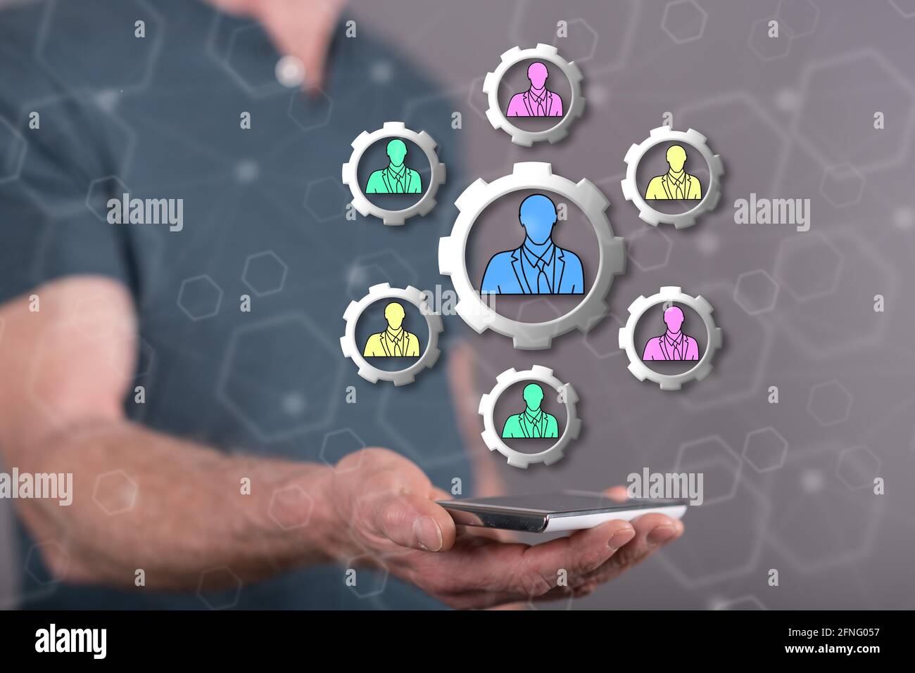 Teamwork concept above a smartphone held by a man in background Stock ...