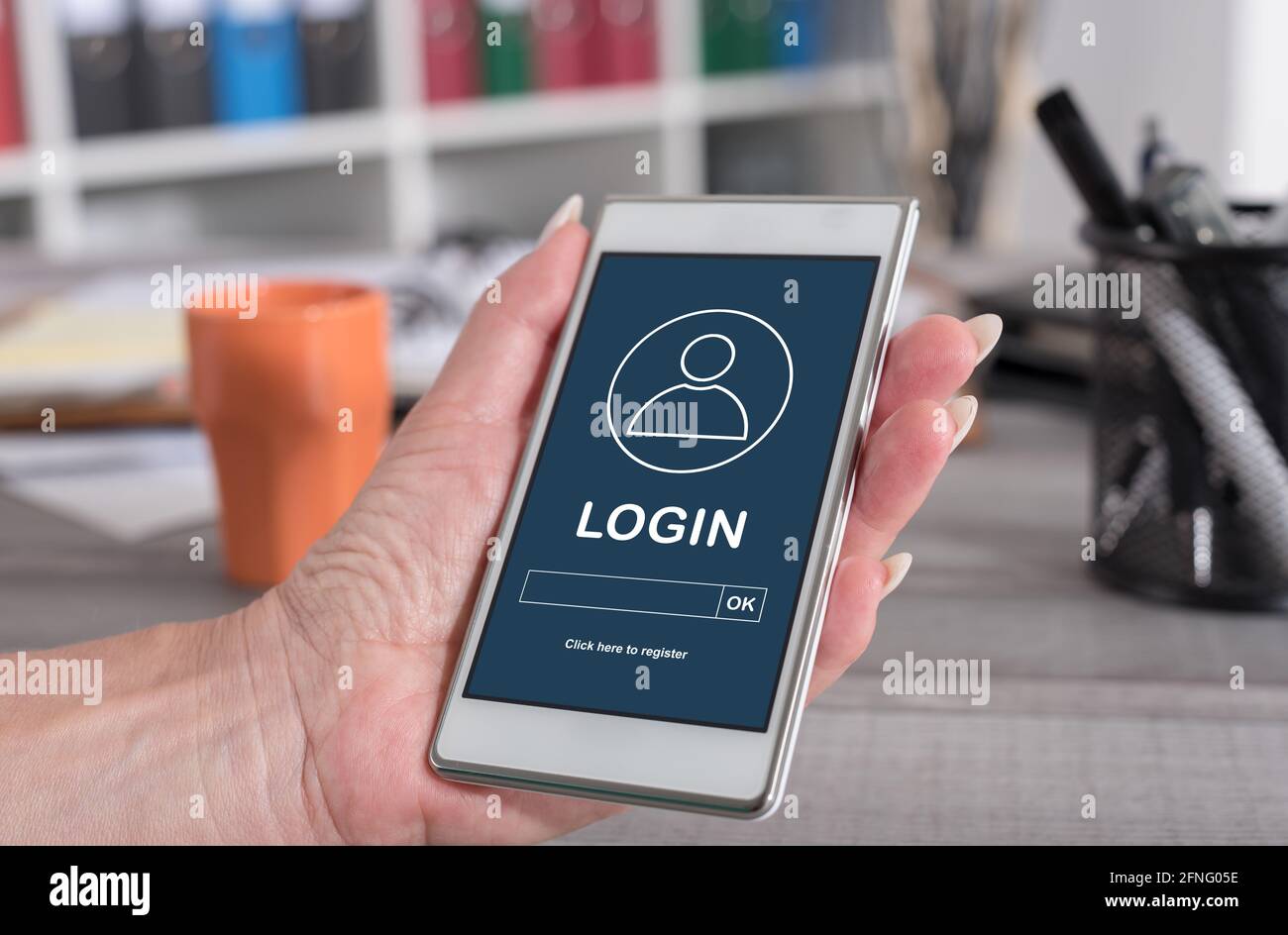 Female hand holding a smartphone with login concept Stock Photo - Alamy