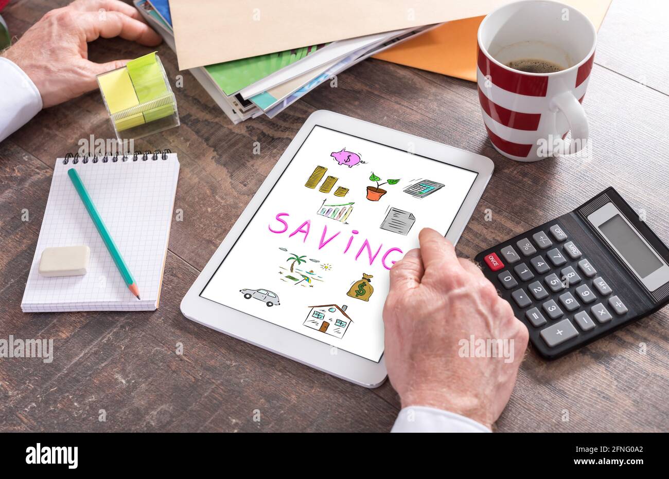 Man using a tablet showing a saving concept Stock Photo - Alamy