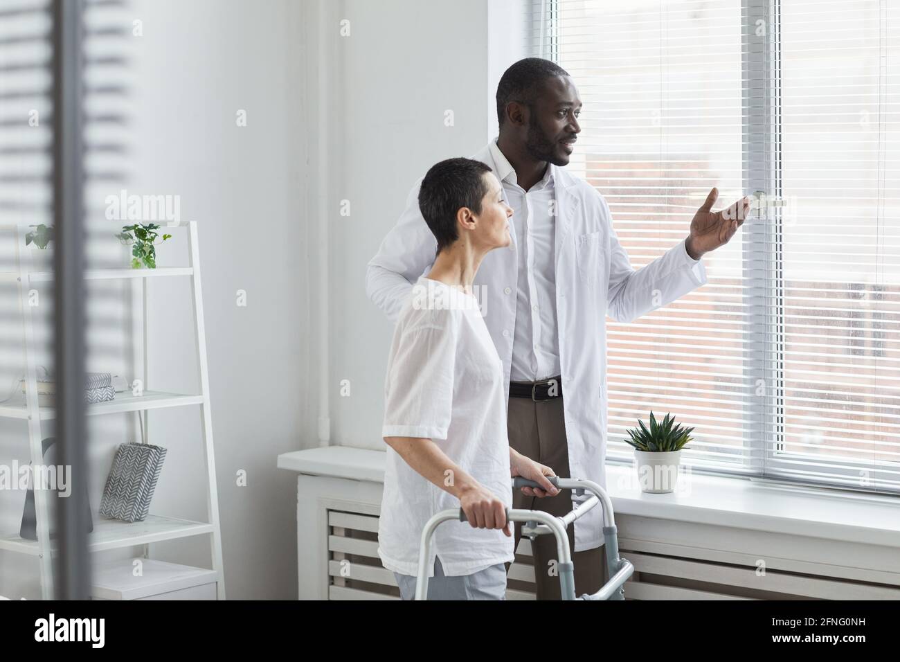 African young doctor showing the hospital ward to patient Stock Photo ...