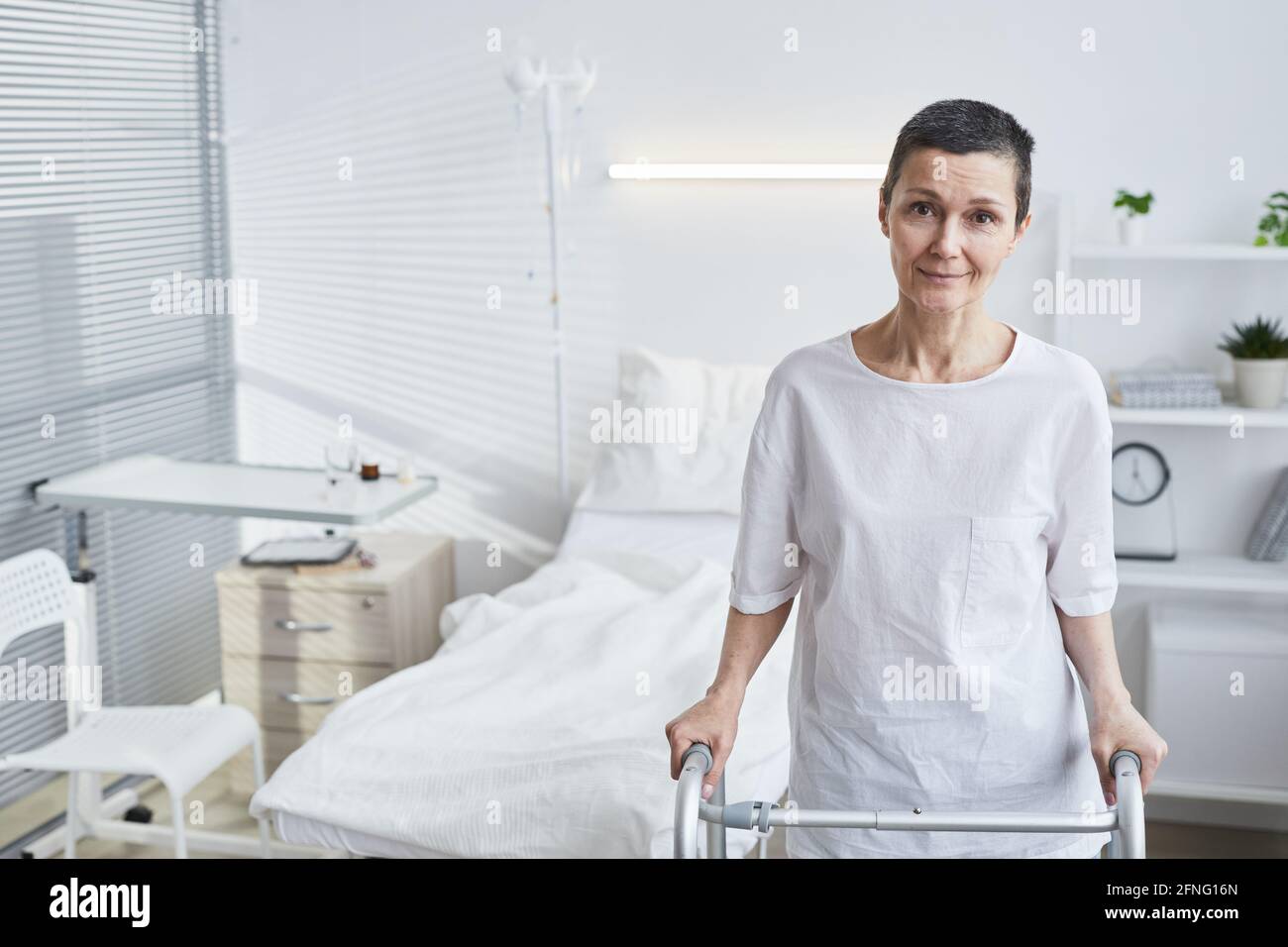 Portrait of senior patient standing at hospital ward Stock Photo - Alamy