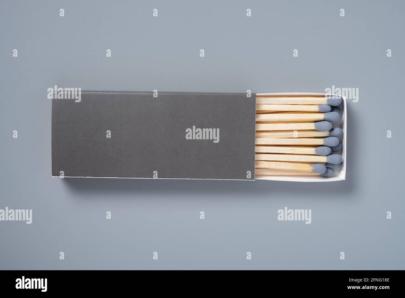grey color matchbox and grey match sticks on a grey background Stock ...