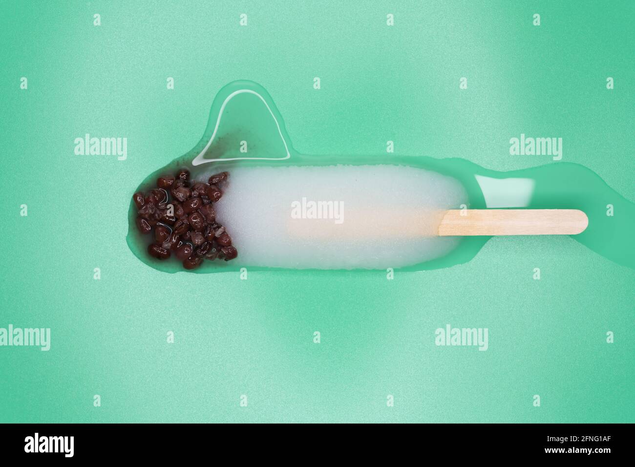 top view half melted red bean popsicle on a green background Stock ...