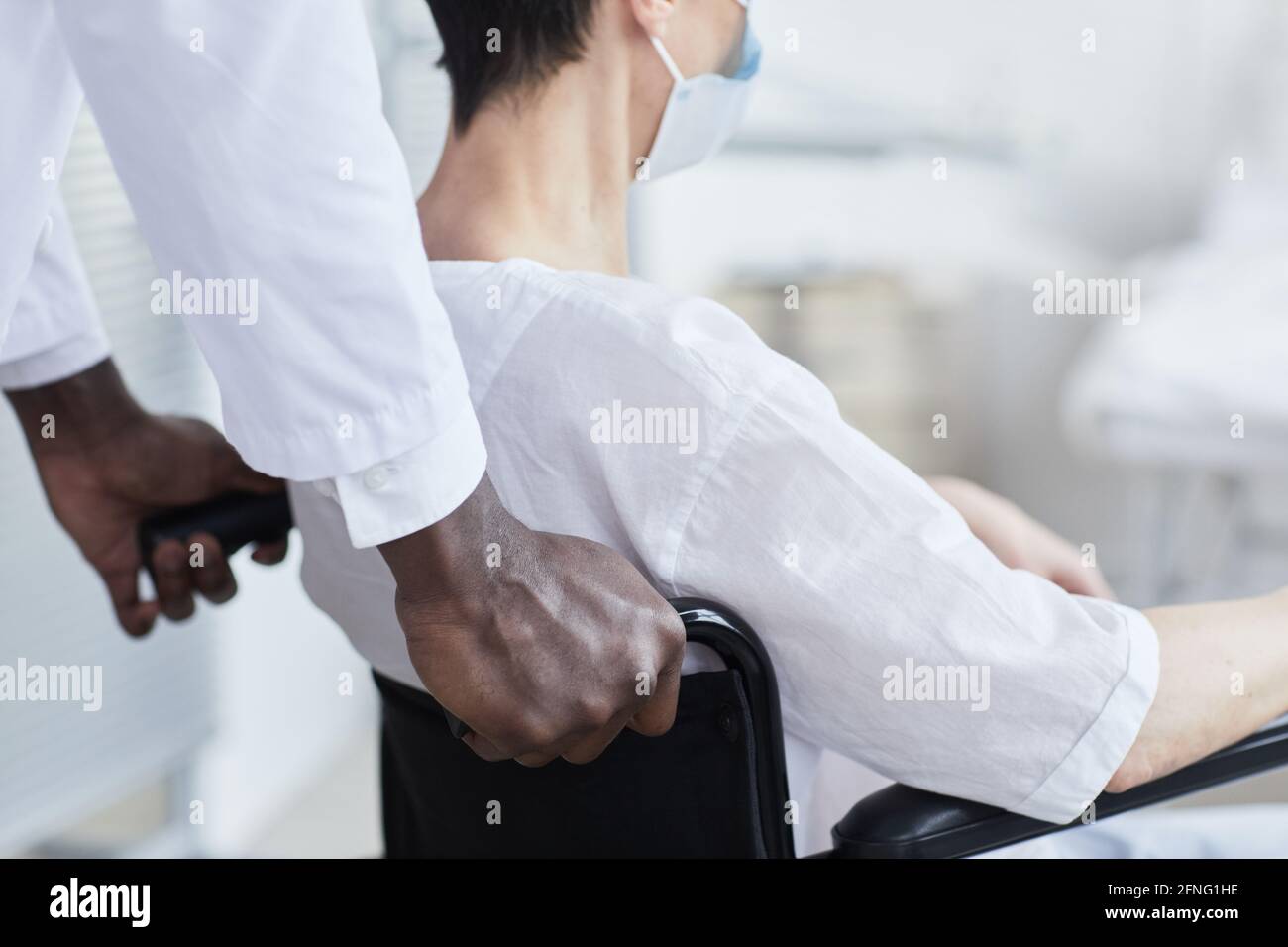 Doctor pushing patient in wheelchair hi-res stock photography and ...