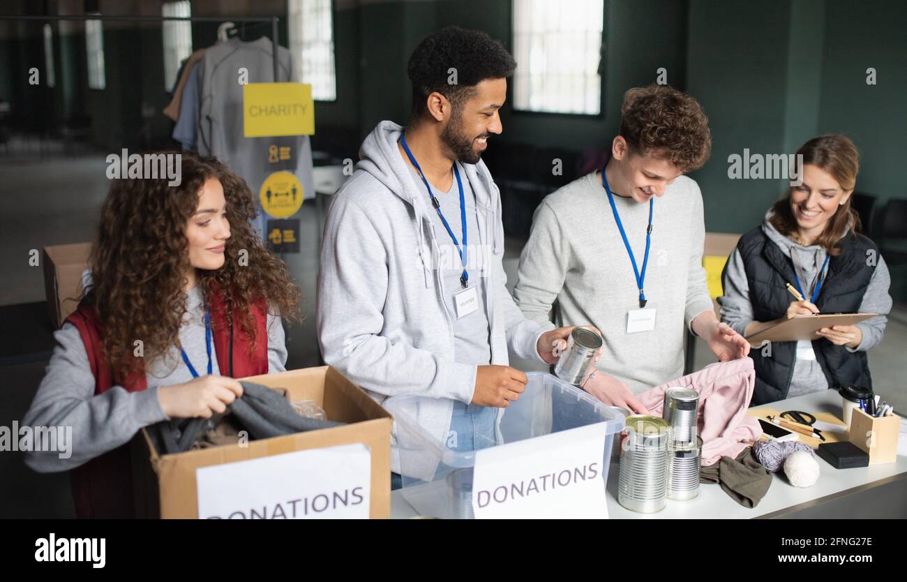 Group of volunteers working in community charity donation center Stock ...