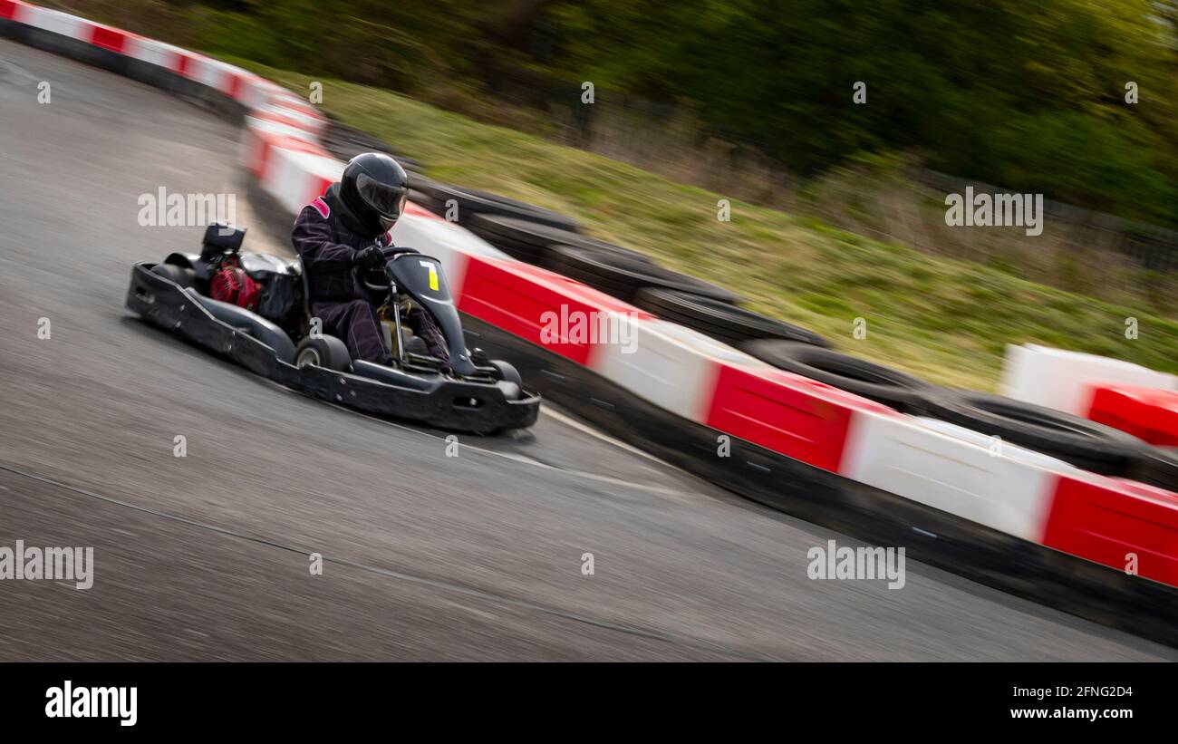 A panning shot of a racing kart as it circuits a track Stock Photo - Alamy