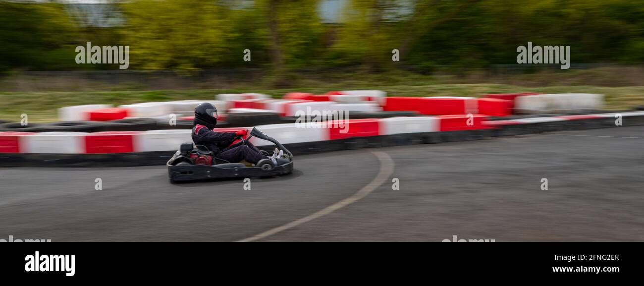 A panning shot of a racing kart as it circuits a track Stock Photo - Alamy