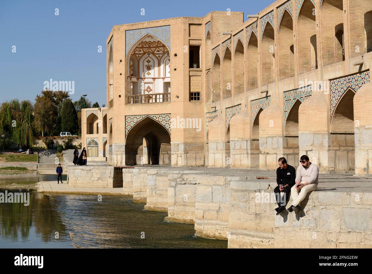 Relaxing people on the historic Khaju bridge over the Zayanderud river ...