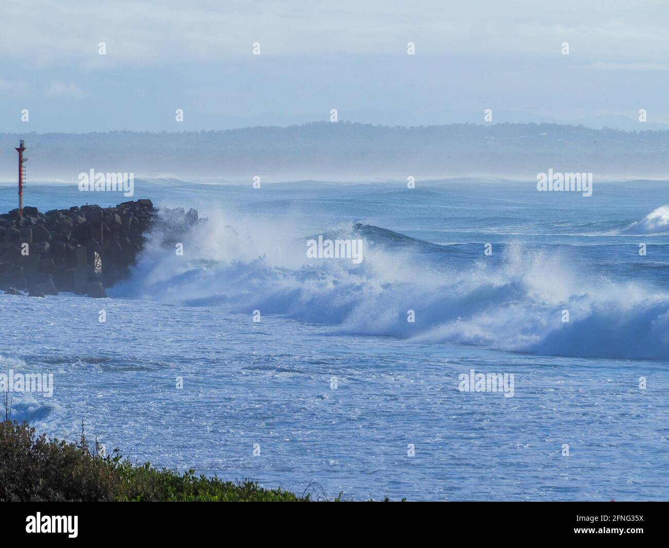 Majestic hazy misty seascape with pretty pale blue water and waves ...