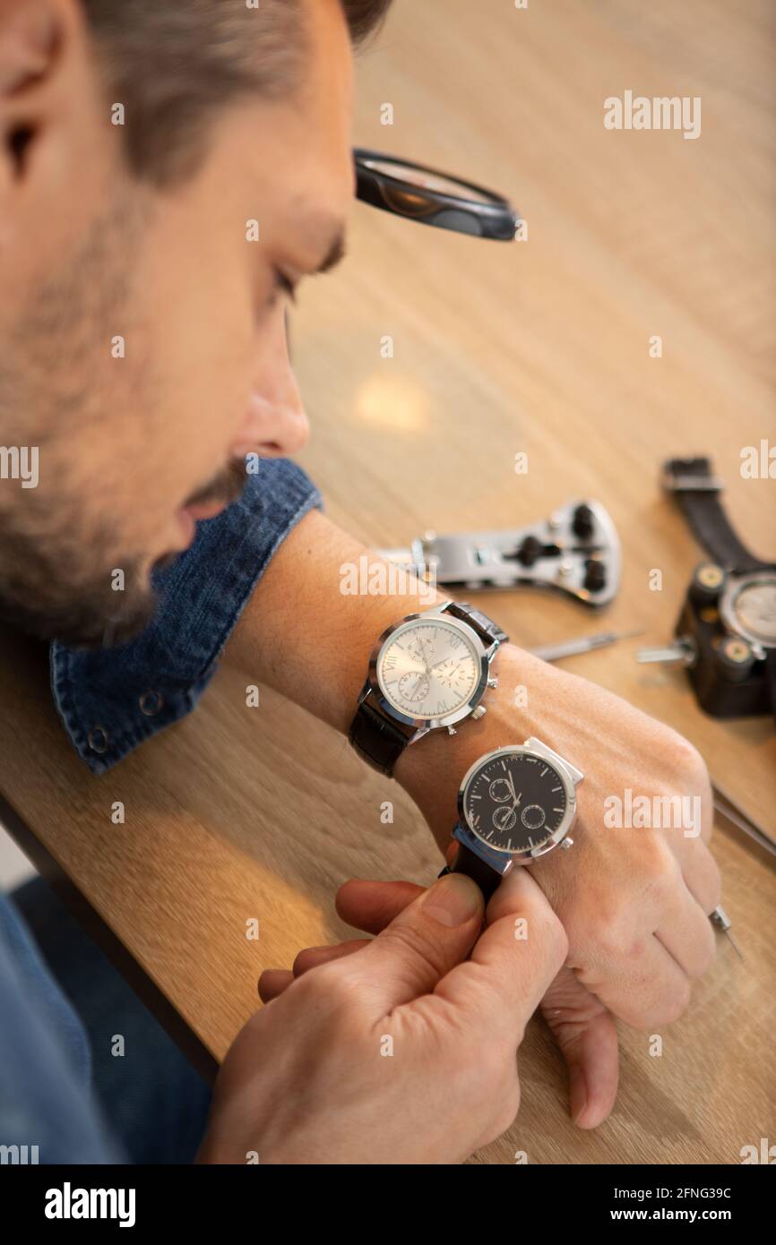 clockmaster is fixing watch for a customer Stock Photo - Alamy